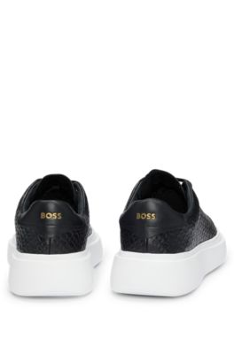 BOSS - Cupsole trainers in leather with embossed monograms - Black