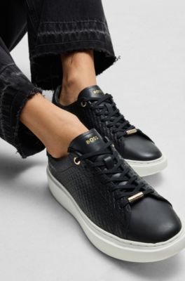 BOSS - Cupsole trainers in leather with embossed monograms - Black