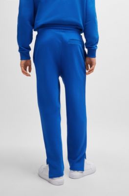 HUGO - Loose-fit cotton-terry tracksuit bottoms with outline logo - Blue