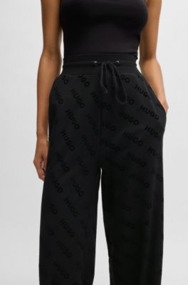 HUGO - Drawstring tracksuit bottoms with flock-printed logos - Black ...