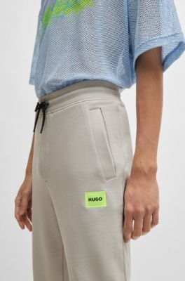 HUGO - Cotton-terry tracksuit bottoms with red logo label - Light Grey