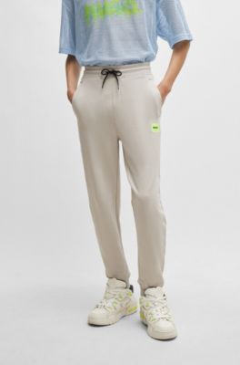 HUGO - Cotton-terry tracksuit bottoms with red logo label - Light Grey