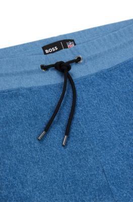 BOSS - BOSS x NFL oversize-fit tracksuit bottoms in denim-look cotton ...
