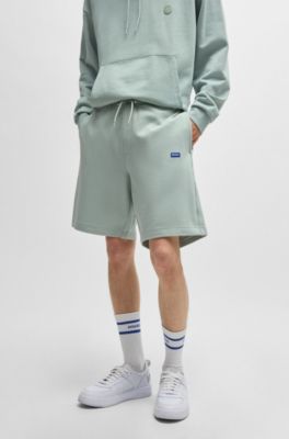HUGO - Cotton-terry shorts with blue logo patch - Light Green