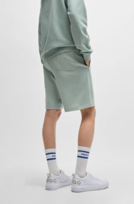 HUGO - Cotton-terry shorts with blue logo patch - Light Green